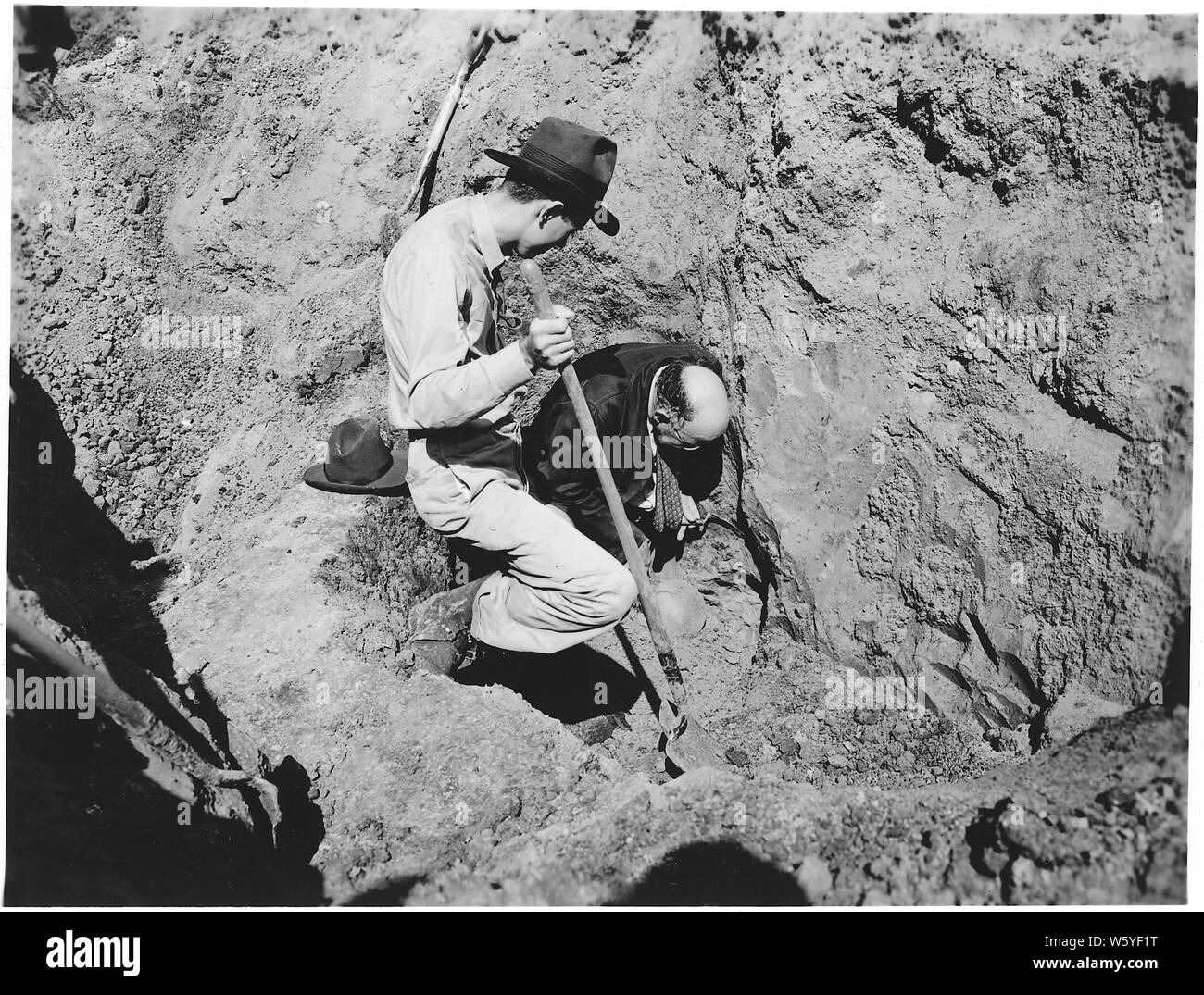 Unearthing dinosaur bones. Cornhusker Ordnance Plant, Nebraska.; Scope ...