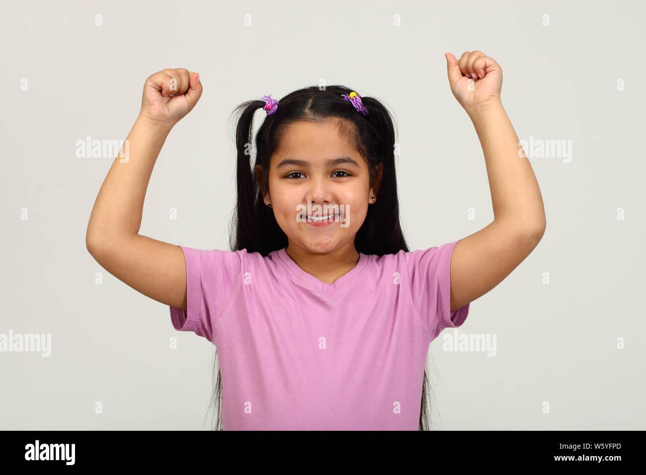 Girl with arm outstretched and smiling Stock Photo - Alamy