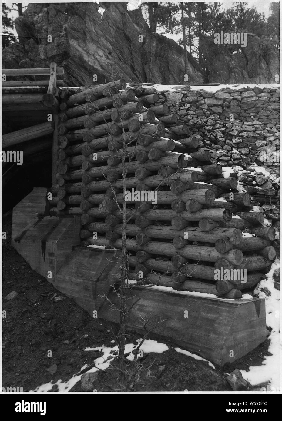 View of log structure support on side of bridge with traces of snow ...