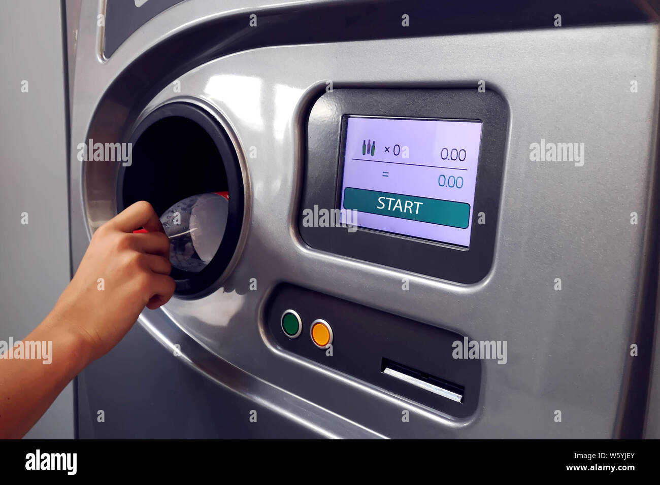 Man returns bottles and cans of reusable packagings in reverse vending ...