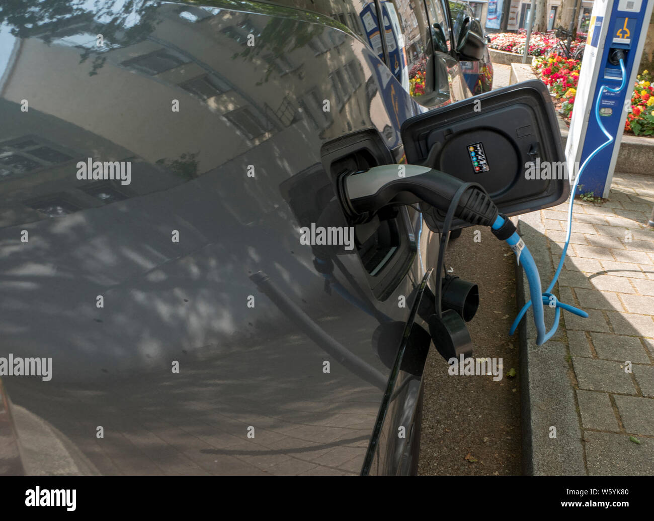 Electric car is charged at an electric filling station Stock Photo - Alamy