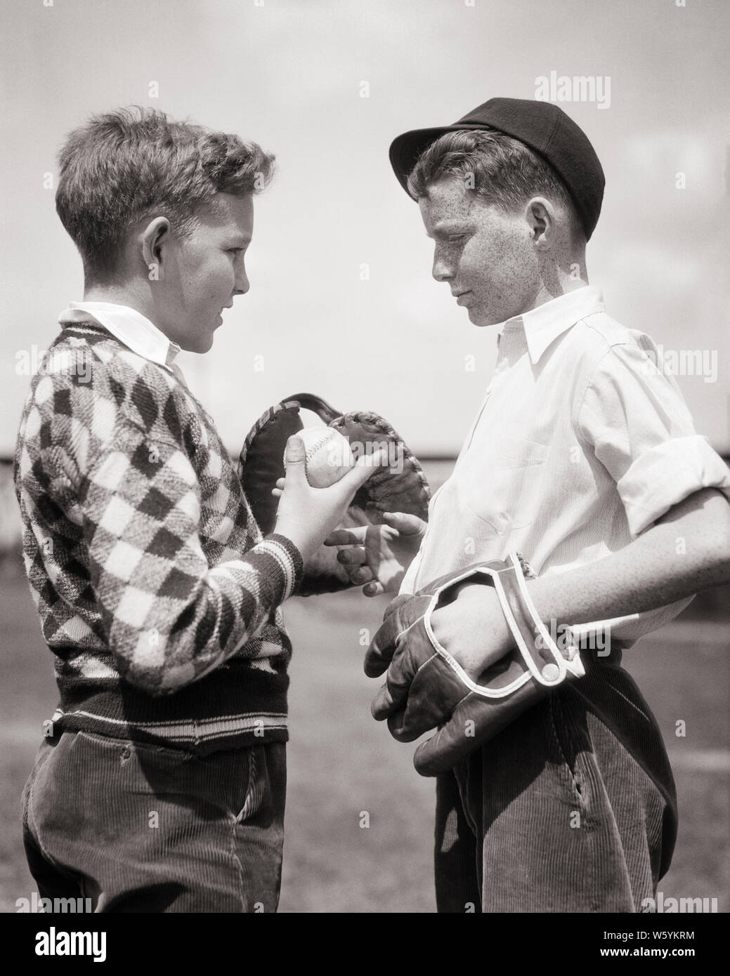 1930s TWO BOYS TALKING PLAYING BASEBALL CATCHER HAND GESTURING ON LEFT ...