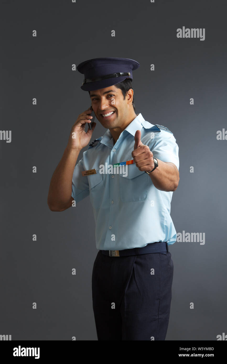 Airforce pilot talking on a mobile phone showing thumbs up sign Stock ...