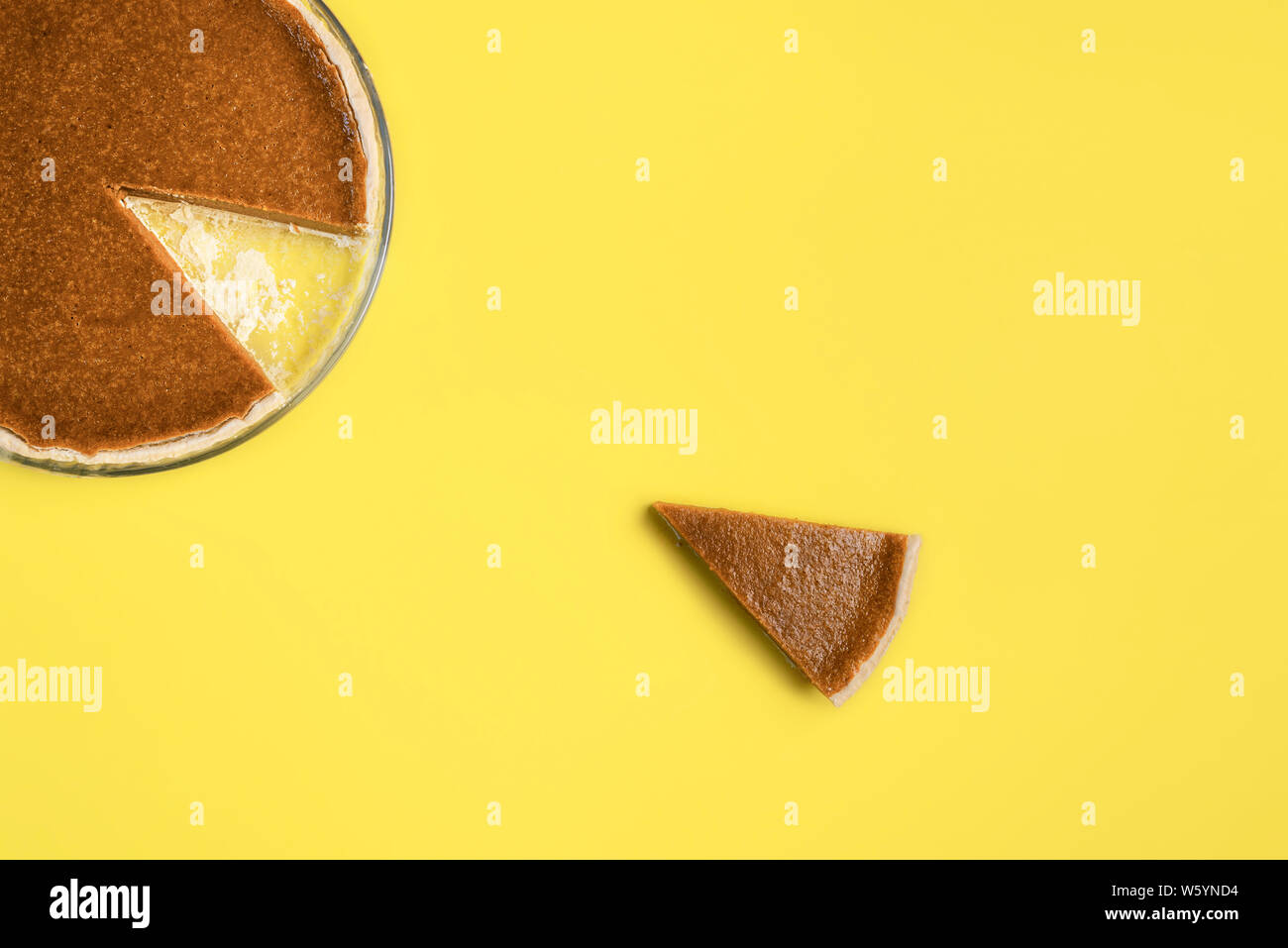 Portion of pie on yellow background. Pumpkin pie slice separated from ...