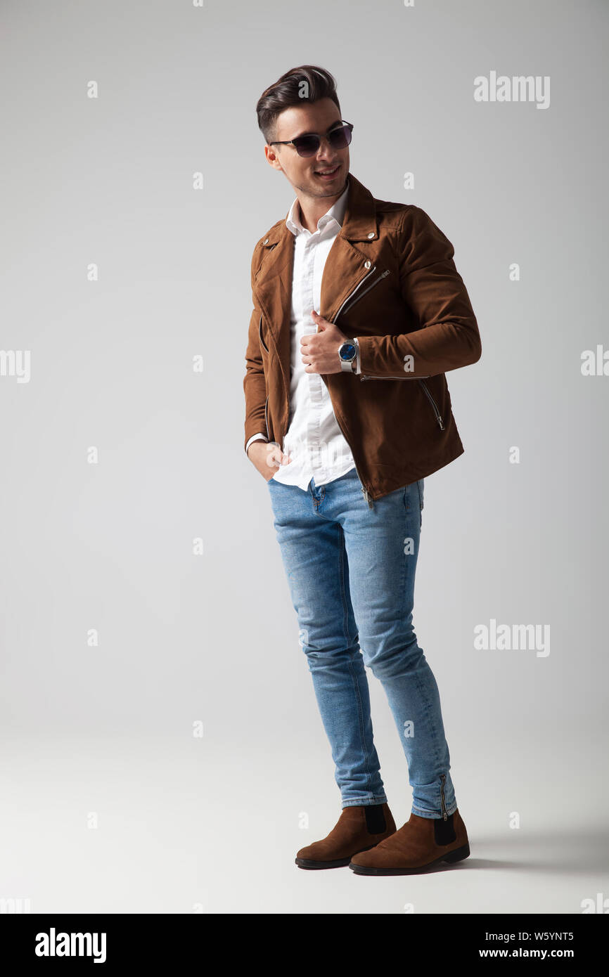 happy casual man looks back over his shoulder in studio Stock Photo - Alamy