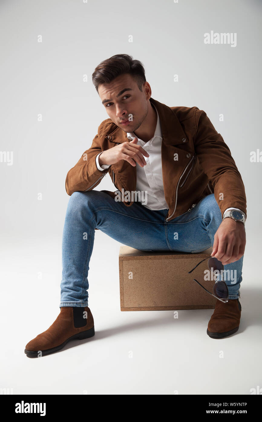 Male model sitting on box hi-res stock photography and images - Alamy