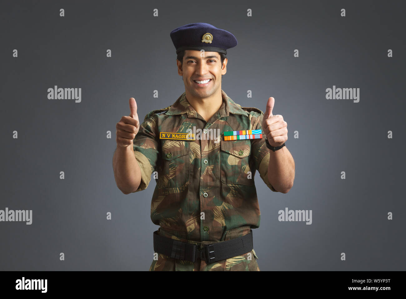 Army soldier showing thumbs up sign and smiling Stock Photo - Alamy