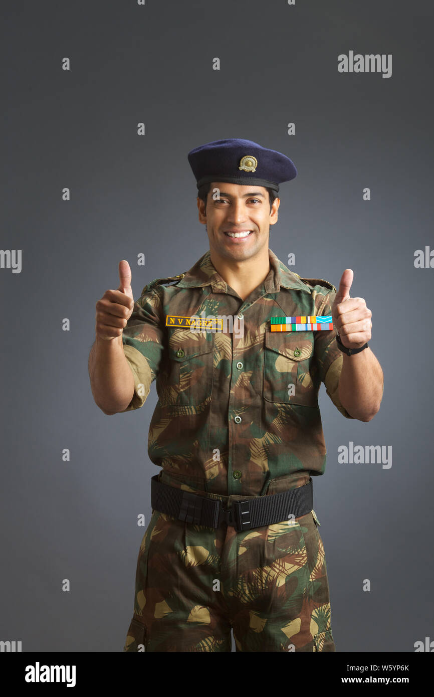 Army soldier showing thumbs up sign and smiling Stock Photo - Alamy