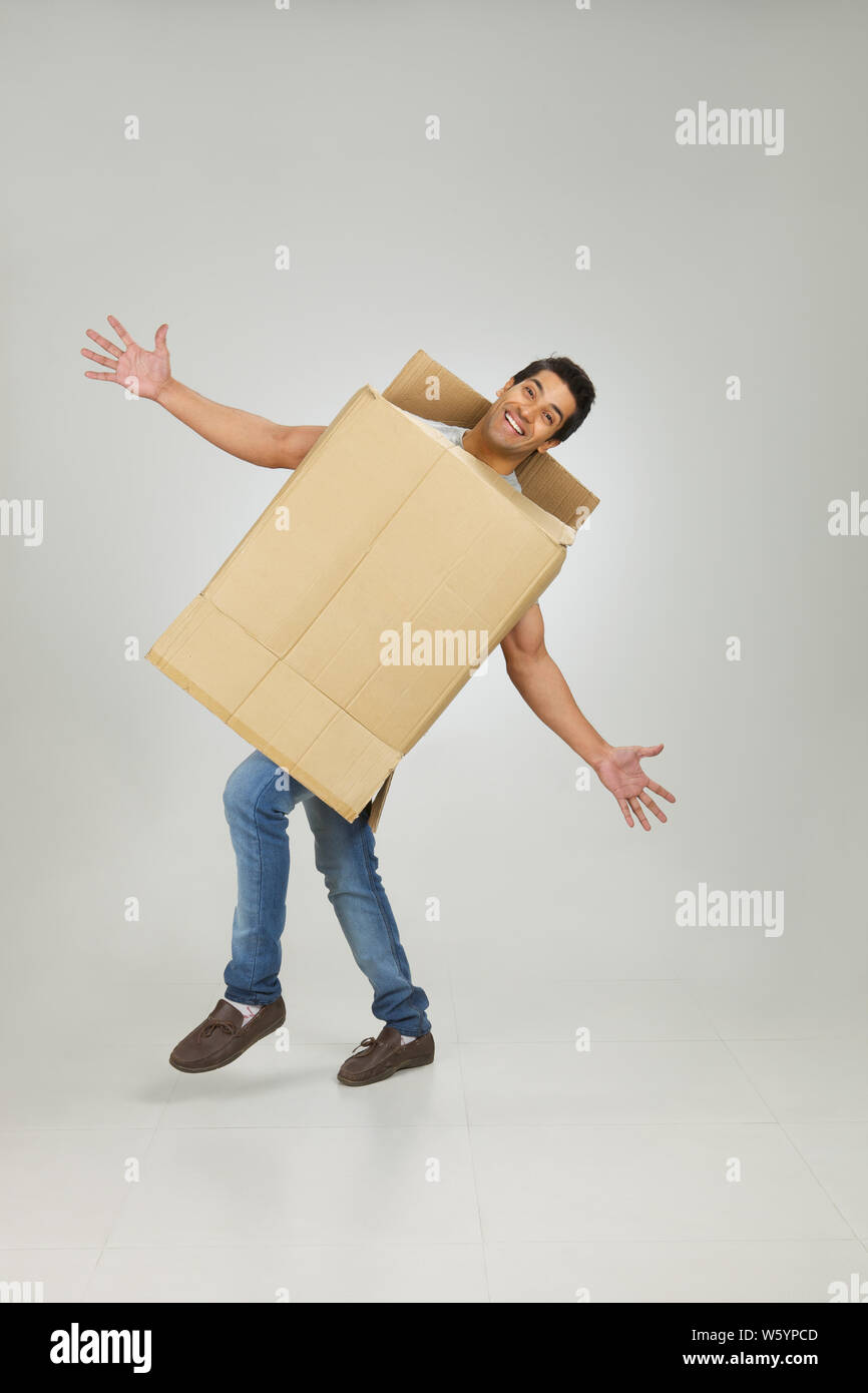 Man wearing cardboard box having fun Stock Photo - Alamy