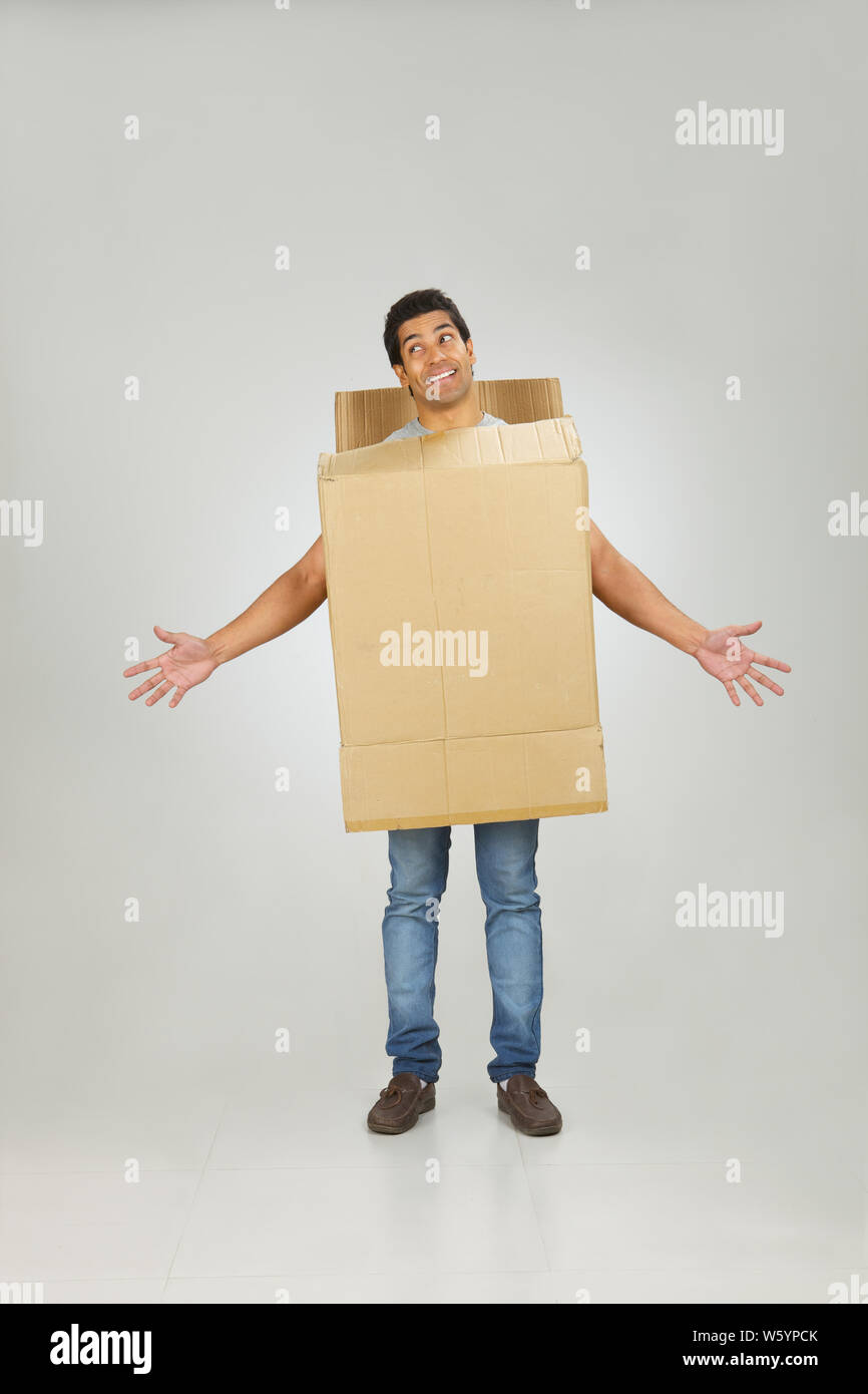 Man wearing cardboard box smiling Stock Photo - Alamy