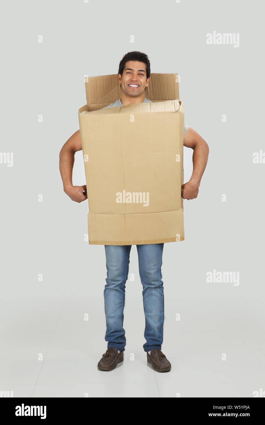 Man wearing cardboard box smiling Stock Photo - Alamy
