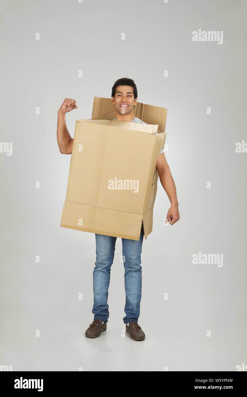 Man wearing cardboard box flexing muscles Stock Photo - Alamy