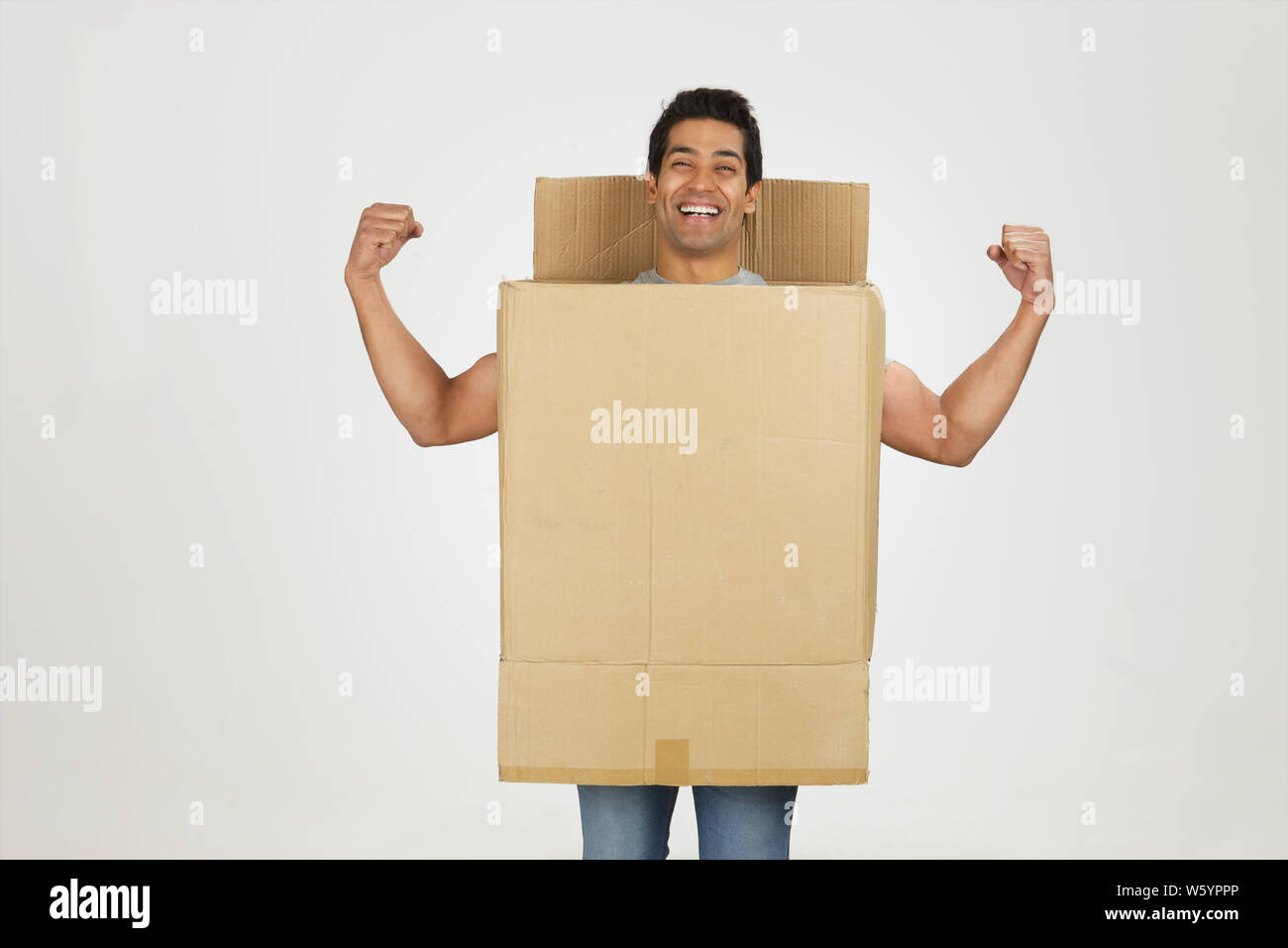 Man wearing cardboard box flexing muscles Stock Photo - Alamy