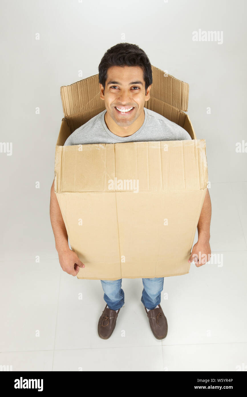 Man wearing cardboard box smiling Stock Photo - Alamy
