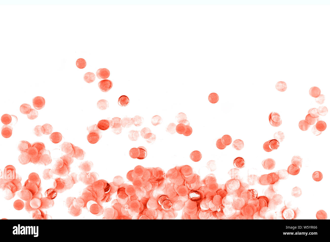 Bright coral confetti isolated on white background Stock Photo - Alamy