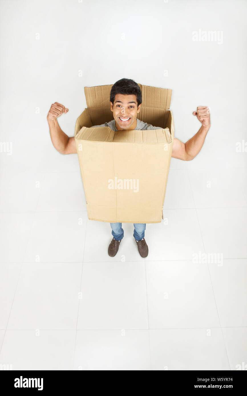 Man wearing cardboard box flexing muscles Stock Photo - Alamy