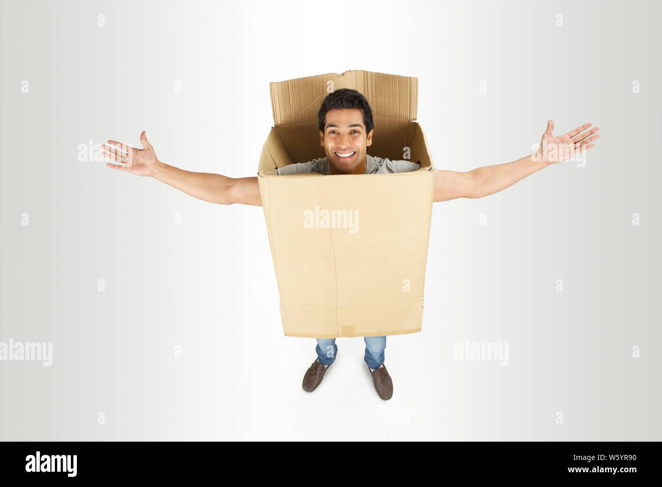 Man wearing cardboard box smiling Stock Photo - Alamy