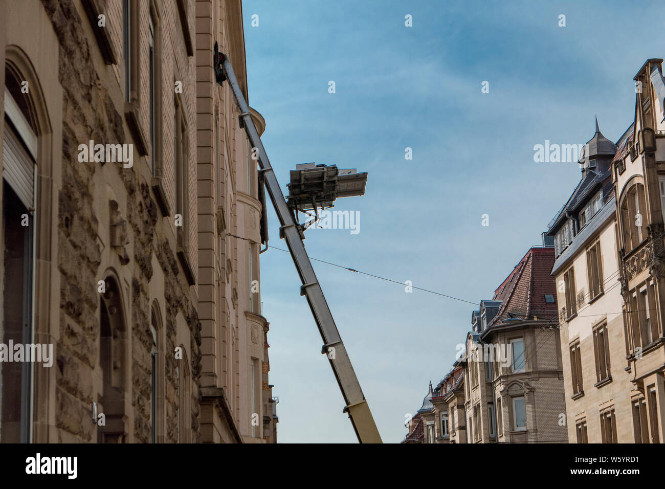 Moving elevator with ladder on the fifth floor in the city Stock Photo ...