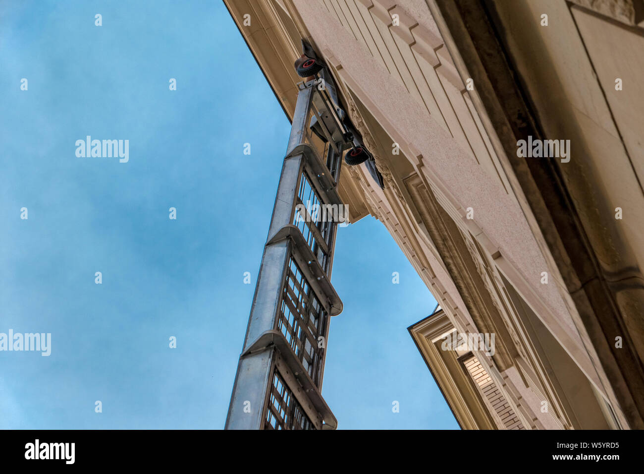 Moving elevator with ladder on the fifth floor in the city Stock Photo ...