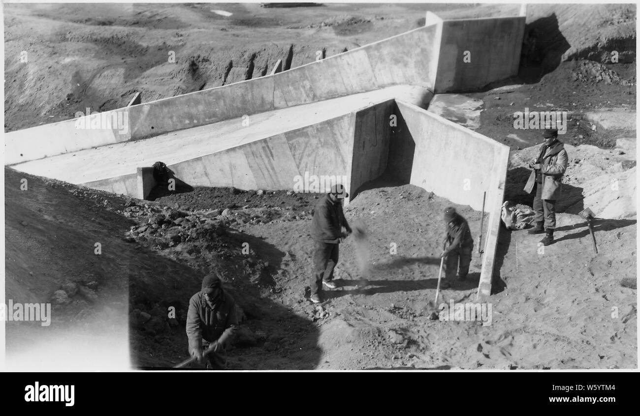 Workers on dam construction project Stock Photo - Alamy
