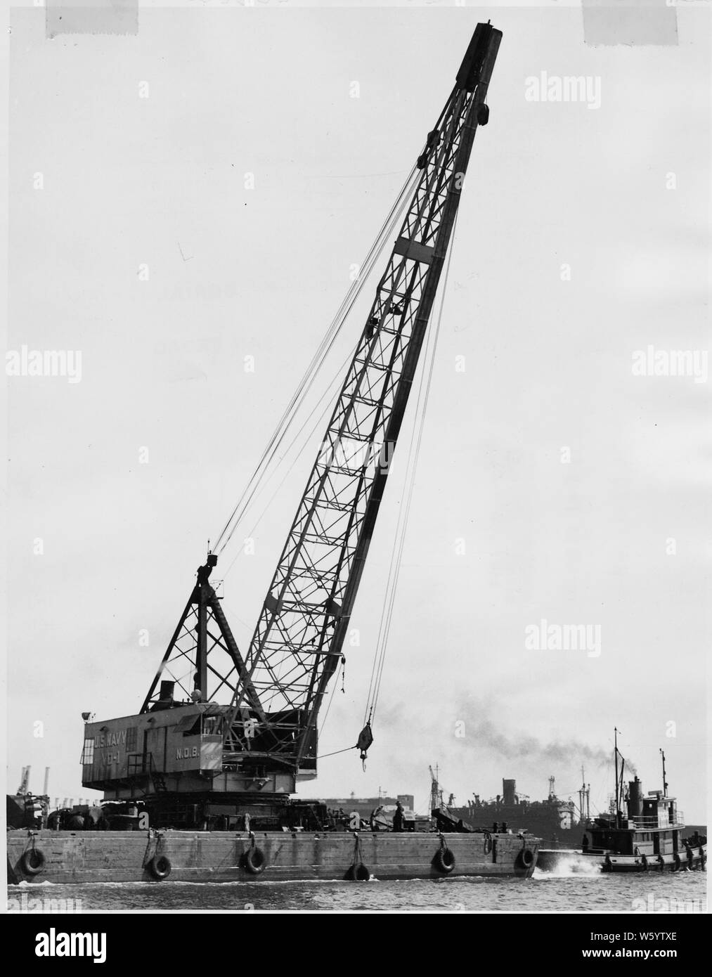 [YD-1, U.S. Navy floating crane being towed out to sea by tug boats ...
