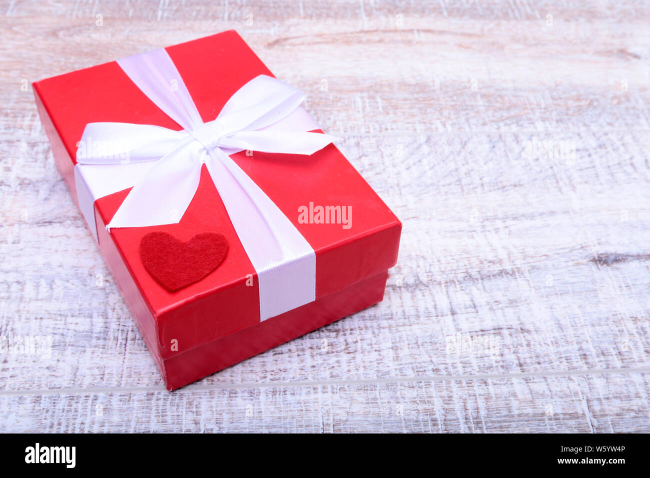 Gift boxes with bow on wood background Stock Photo - Alamy