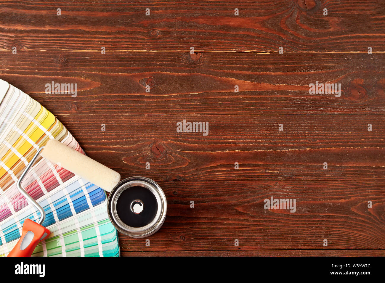 Home renovation concept. Painting roller, can with paint, color guide ...