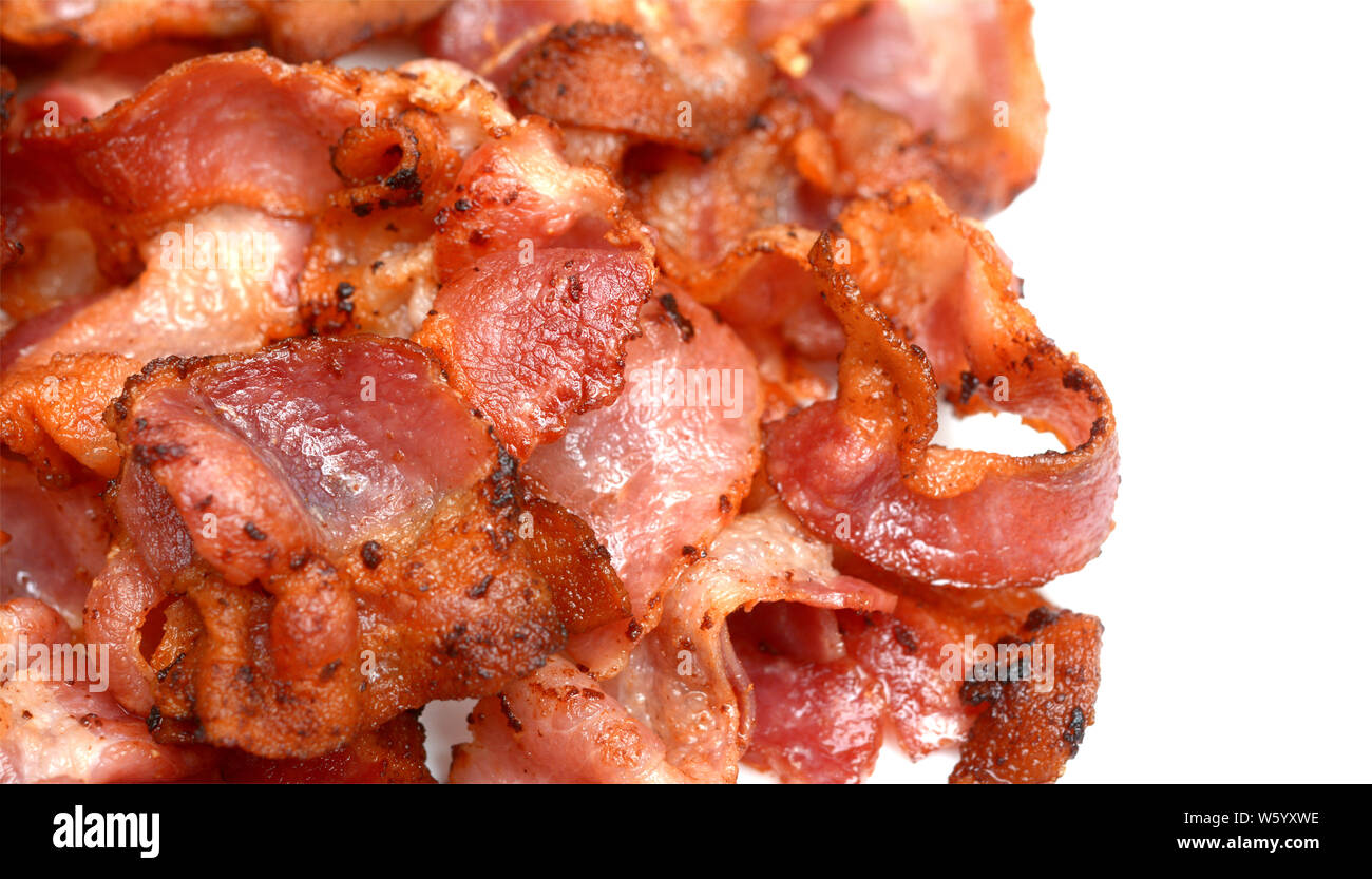 a group fried Bacon strips on white background Stock Photo - Alamy
