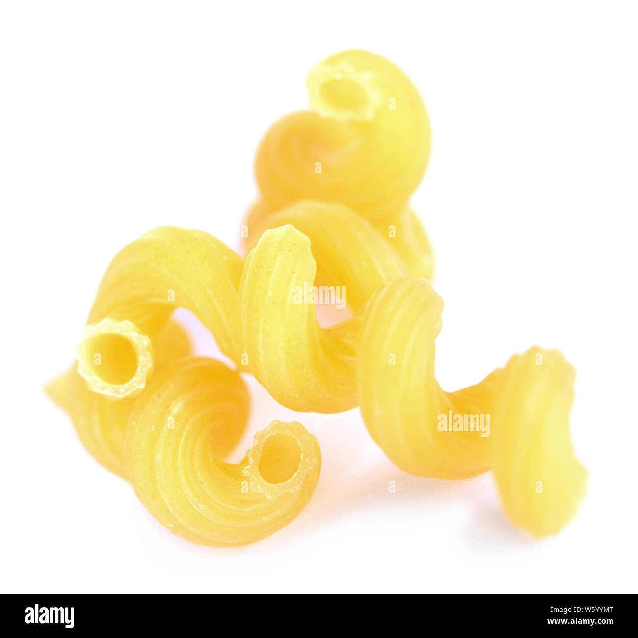 a pile of tube pasta on white background Stock Photo - Alamy