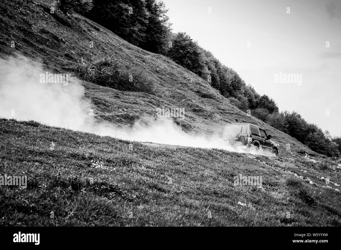 Offroad vehicle on dusty road Stock Photo - Alamy