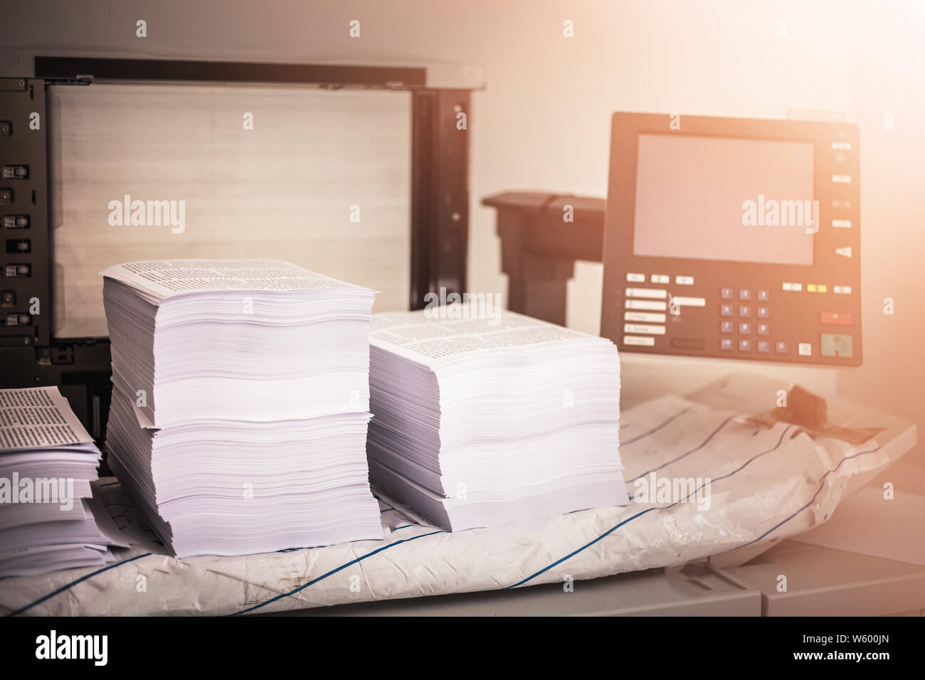 Pile of printed papers on industrial printer Stock Photo - Alamy