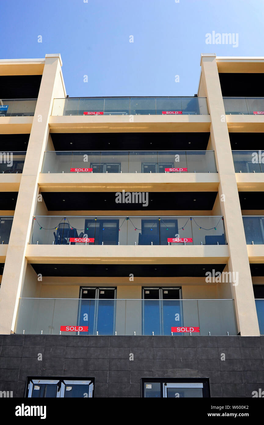 New apartment block with apartments showing sold signs Stock Photo - Alamy