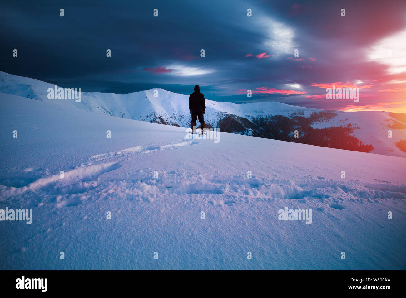 Hikers in beautiful winter landscape at sunrise Stock Photo - Alamy