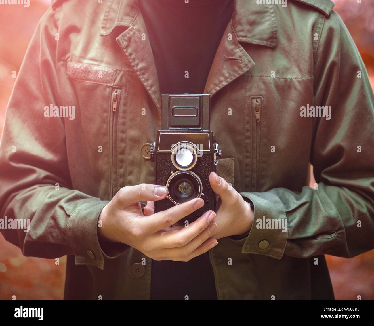Old vintage camera in the hands of the photographer Stock Photo - Alamy