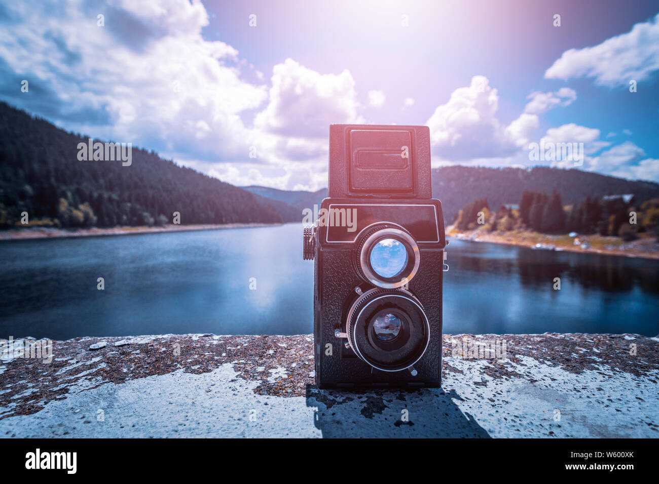 Old vintage camera in lake landscape scenery Stock Photo - Alamy