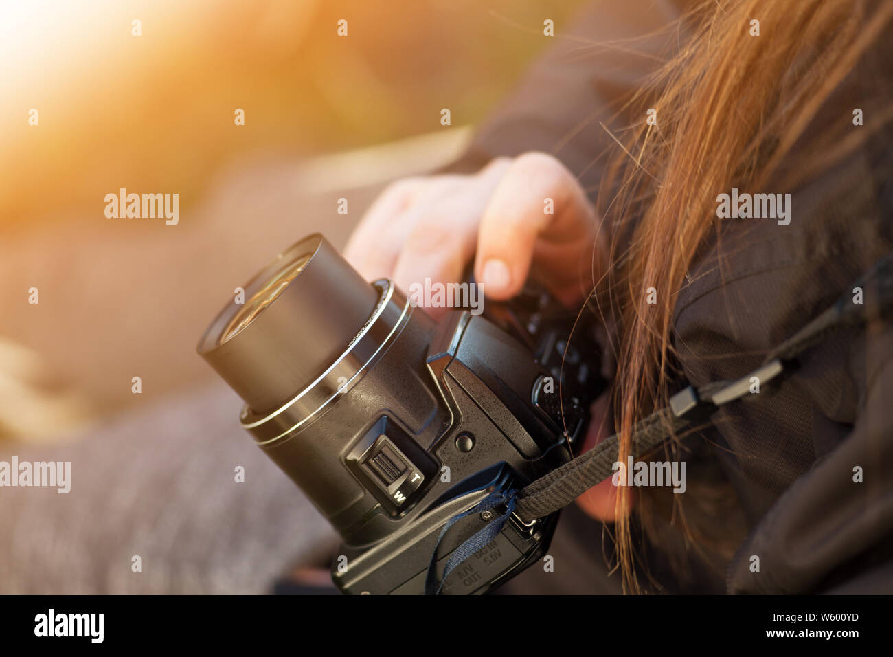 Girl holding camera in her hand Stock Photo - Alamy