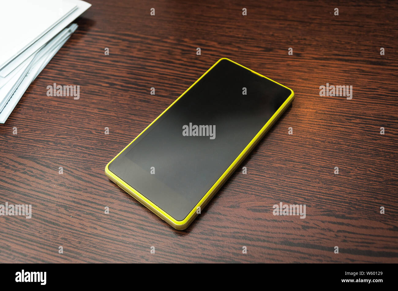 Mobile phone with green lime case frame on desk Stock Photo - Alamy