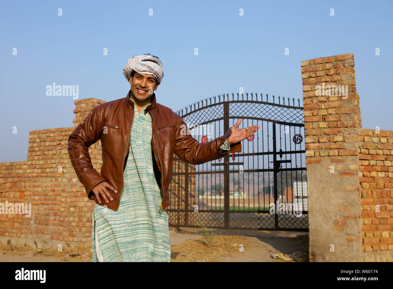 Rural man showing his home and smiling Stock Photo - Alamy