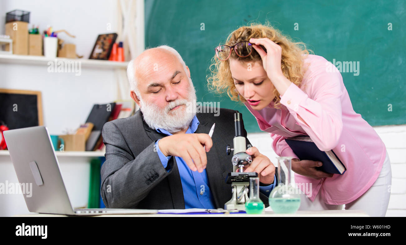 Teacher and girl with notepad near chalkboard. Biology science. Study ...