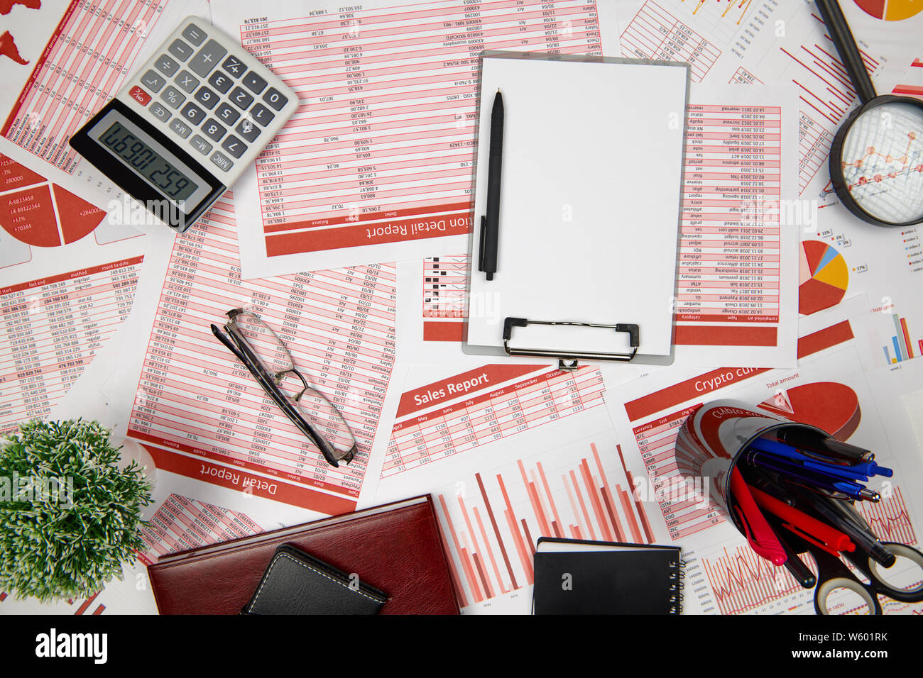 Flat top view of business workspace - reports with data, tables and ...