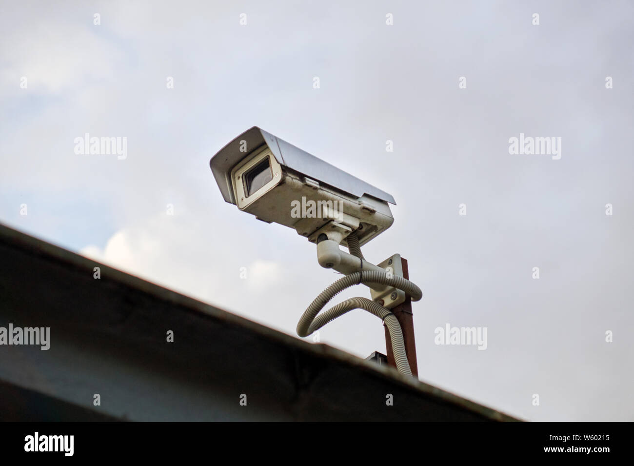outdoor video camera on a cloudy sky background Stock Photo - Alamy