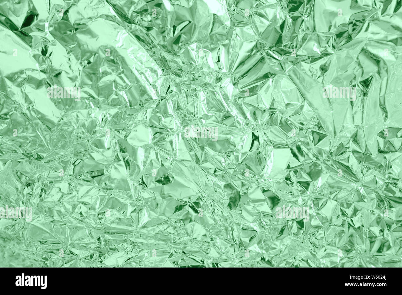 Abstract trendy mint colored crumpled foil texture background. Color ...