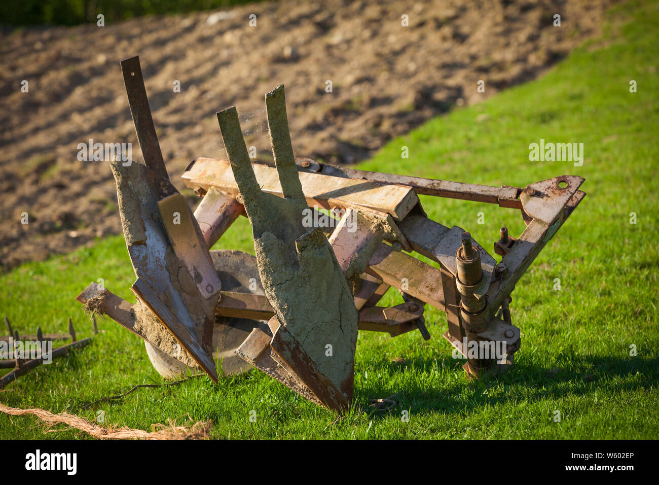 Old plow in mountain landscape with farm land Stock Photo - Alamy