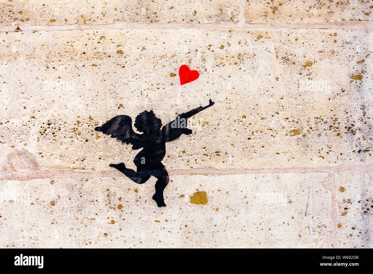 Mural in Paris depicting an angel with gun and a red heart Stock Photo ...