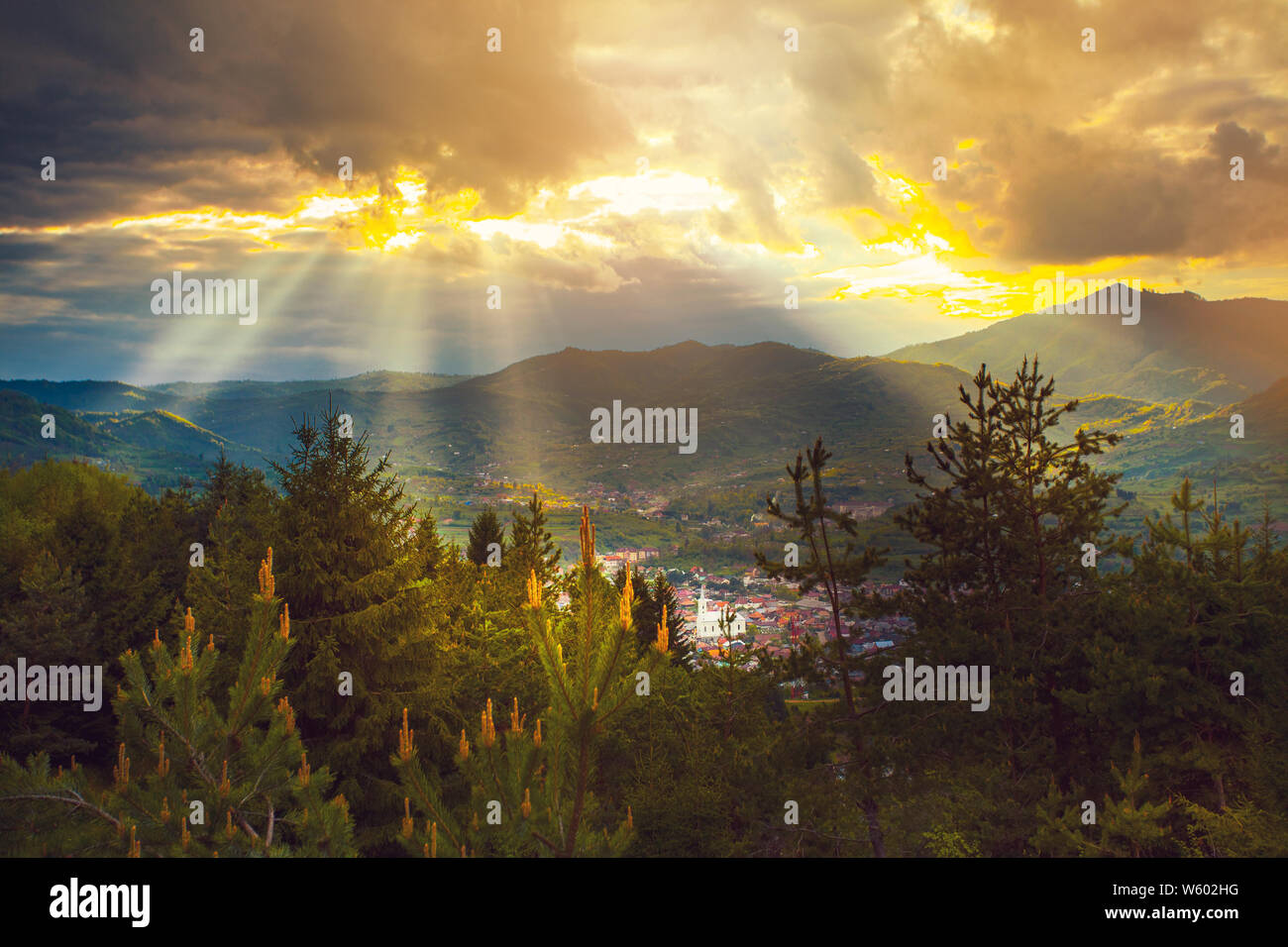 Sun rays beams over rural mountain resort epic landscape Stock Photo ...