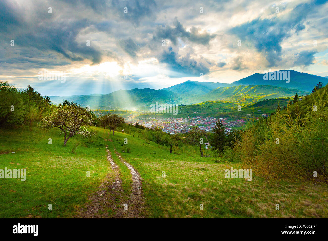 Sun rays beams over rural mountain resort epic landscape Stock Photo ...