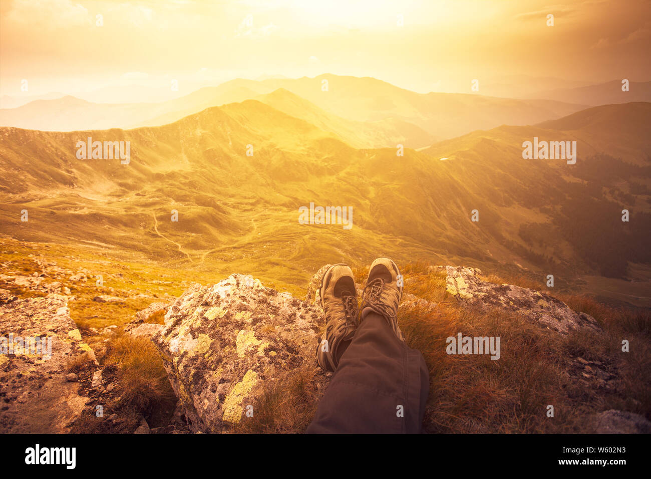 Mountain landscape first person view sitting on a rock admiring the ...