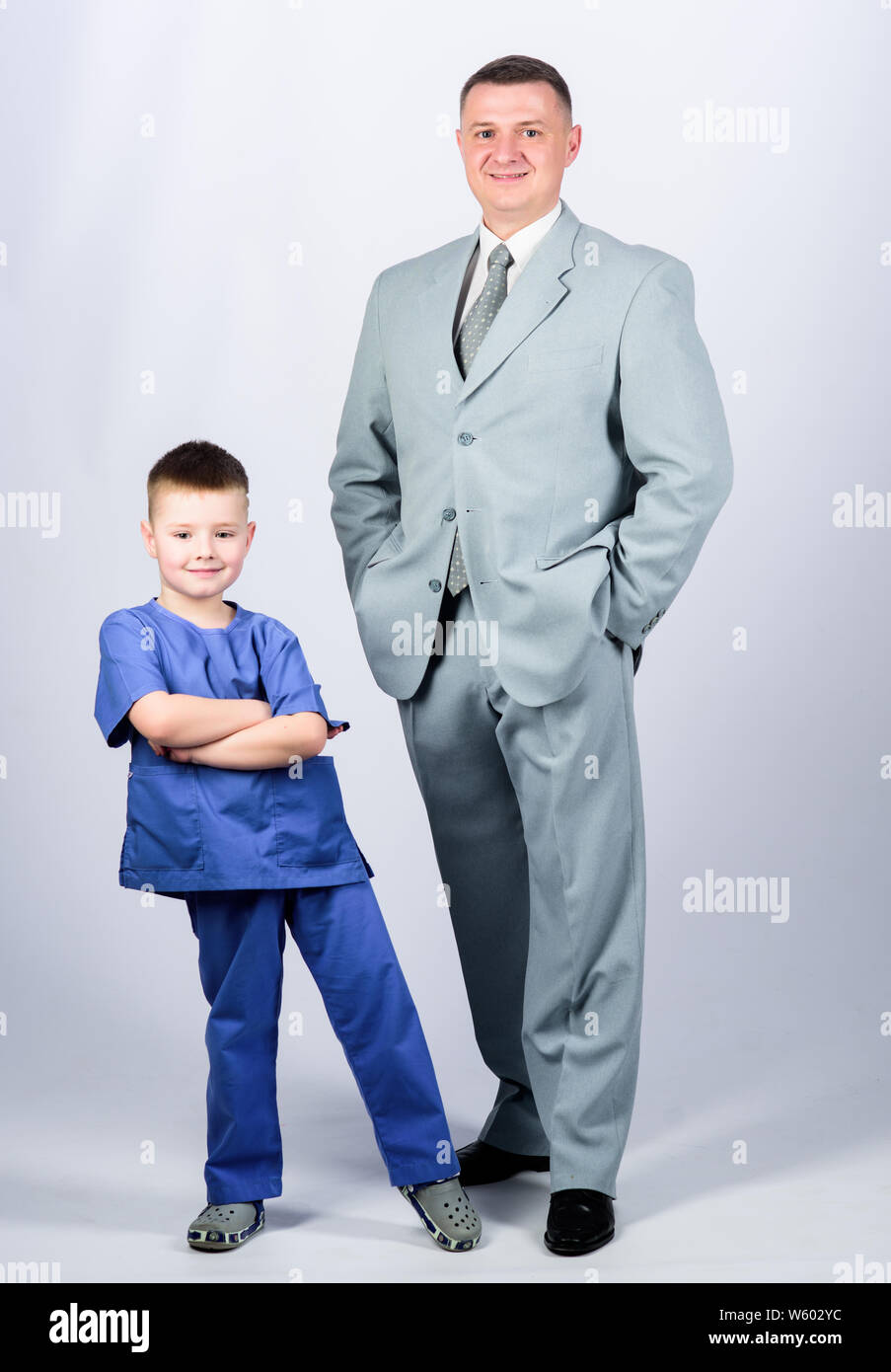 business partner. small boy doctor with dad businessman. childhood ...