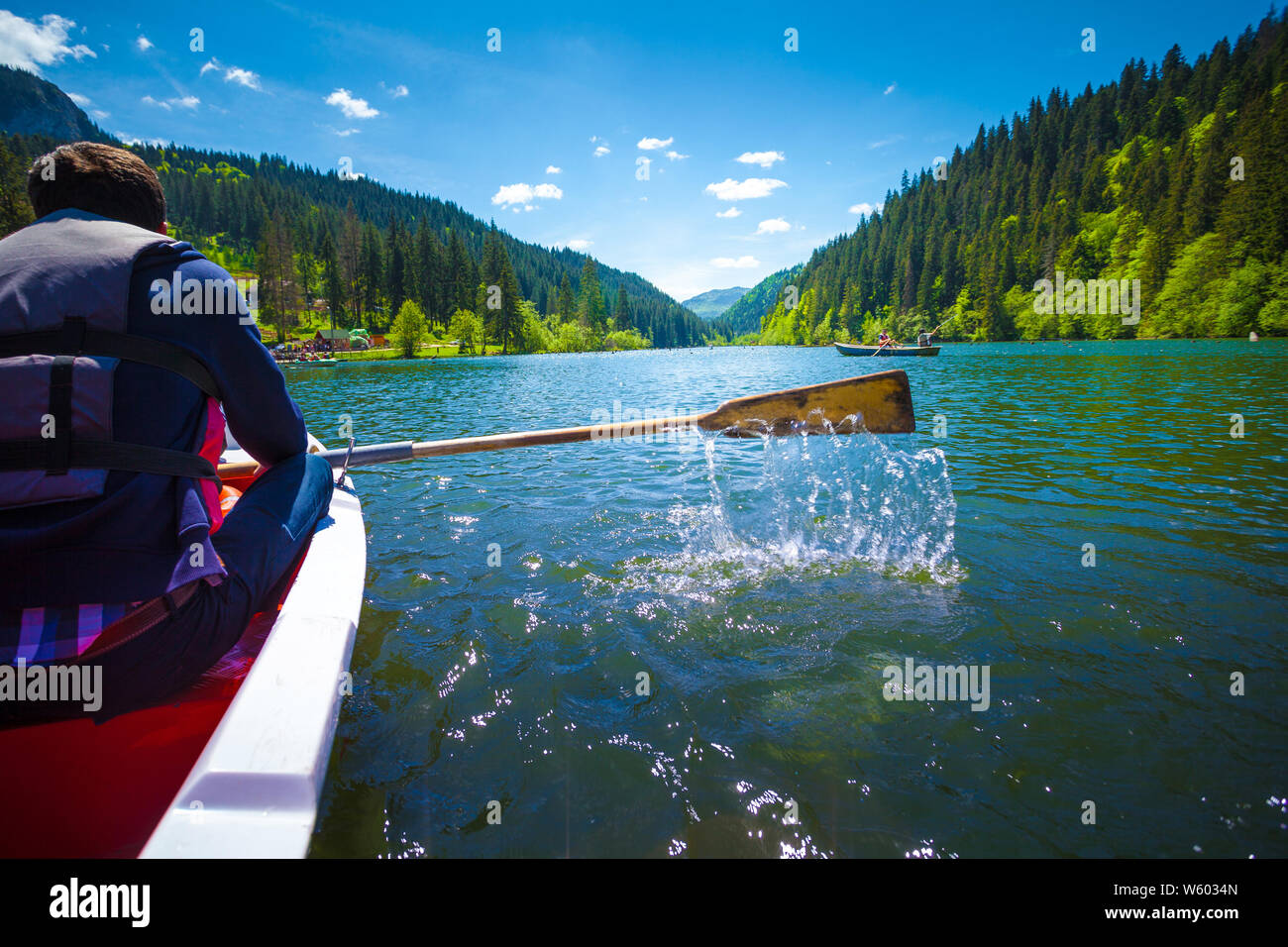 Tourist boat on a mounain lake rowing fast, making a splash Stock Photo ...