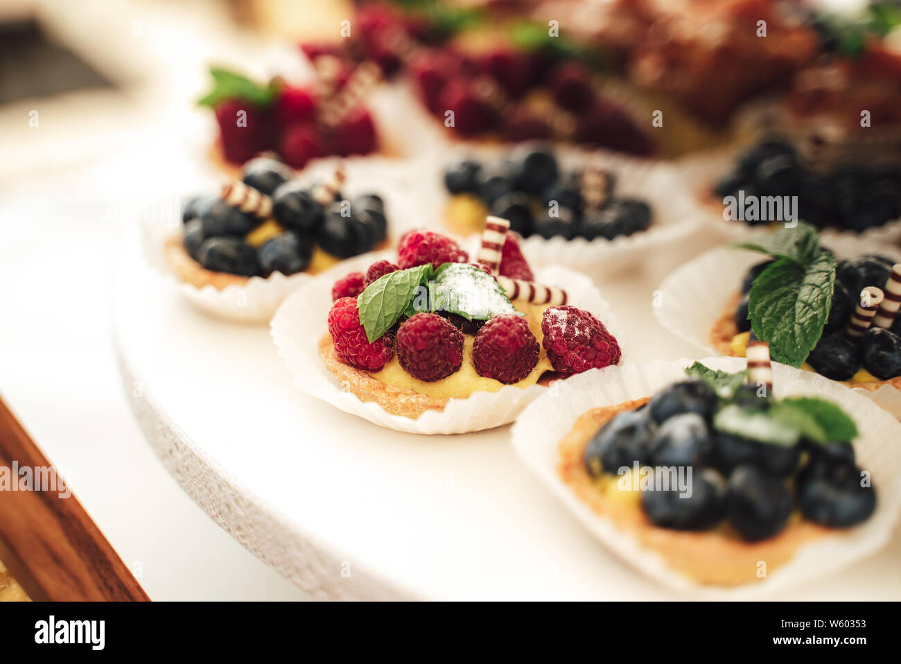 Raspberry custard pastry tart on a display stand Stock Photo - Alamy